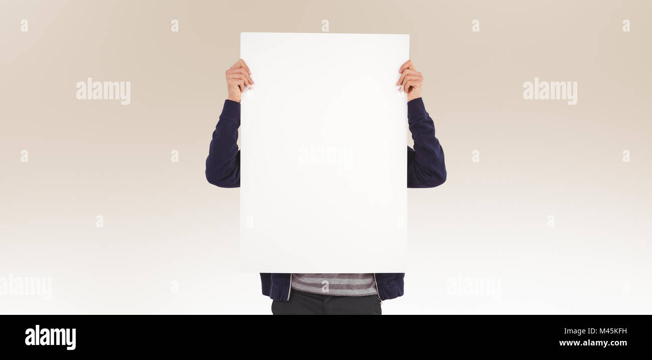 Composite image of man showing billboard in front of face Stock Photo ...