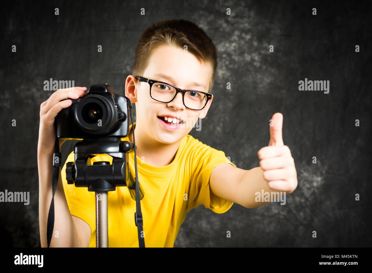 Teenage boy learning how to use a big digital camera Stock Photo - Alamy