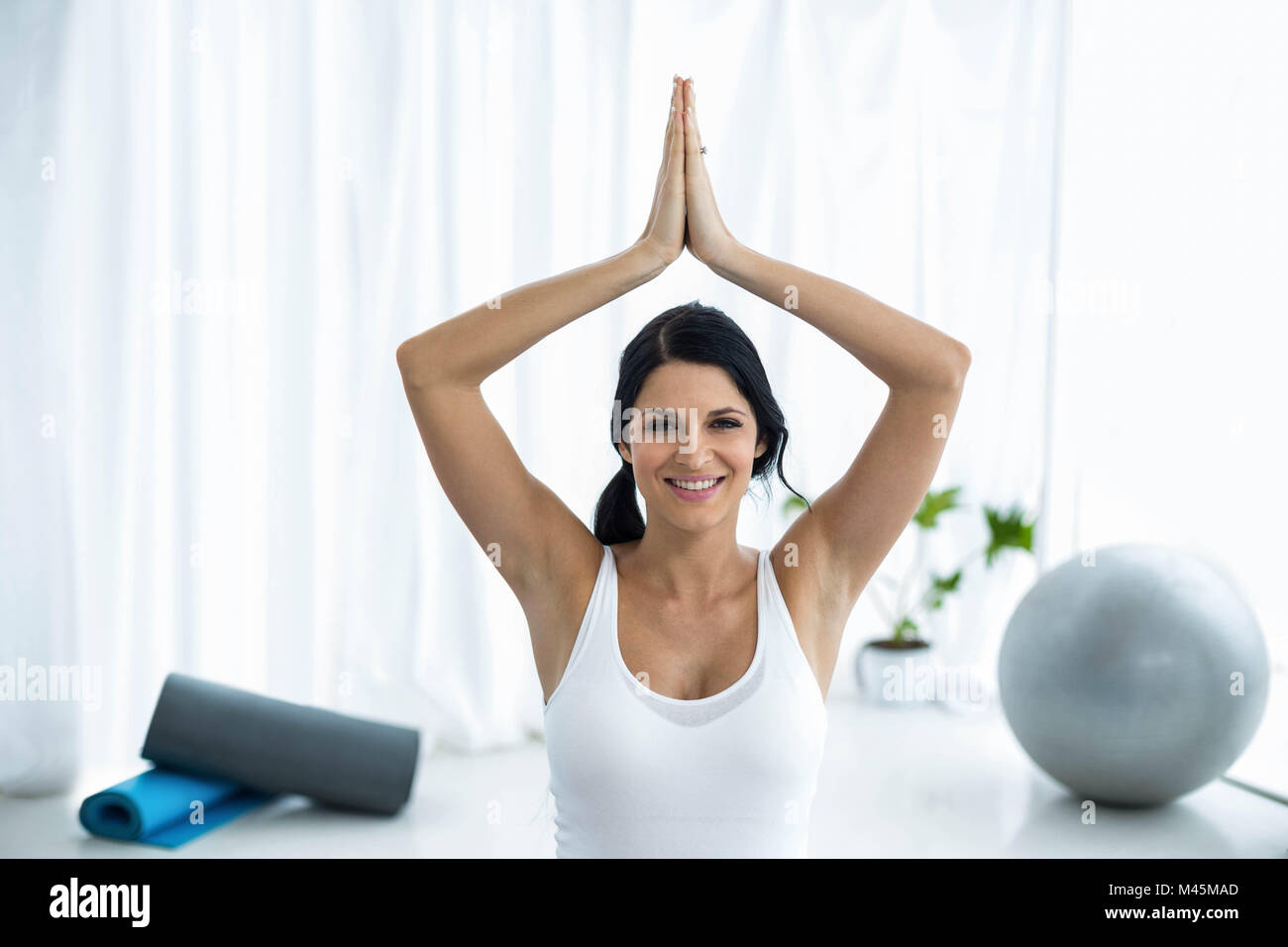 Pregnant woman in prayer position on exercise ball Stock Photo - Alamy