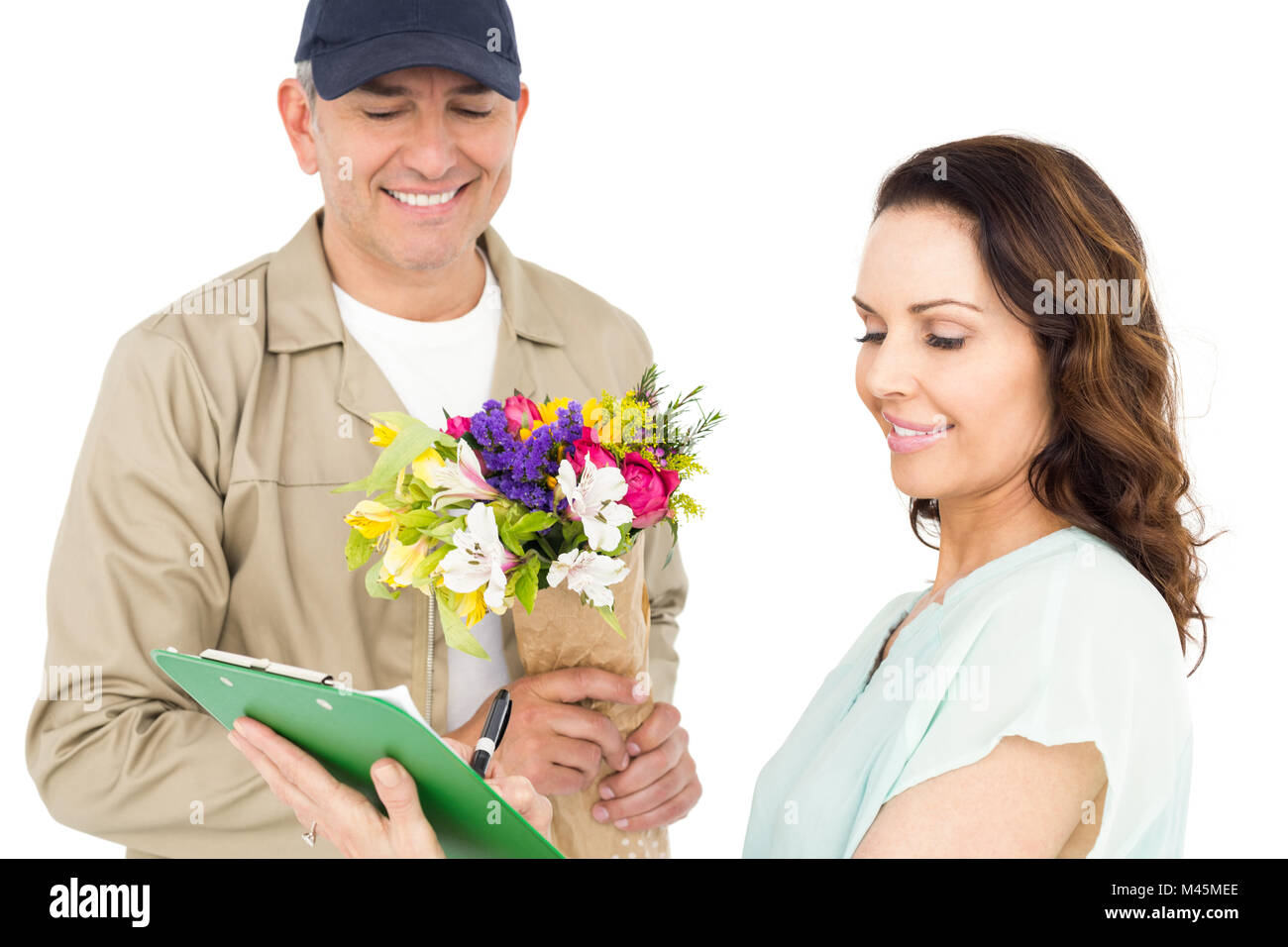 Female customer signing on paper with delivery man Stock Photo - Alamy