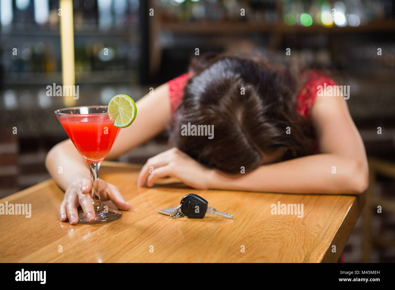 Drunk woman driver leaning on counter with her cocktail Stock Photo - Alamy