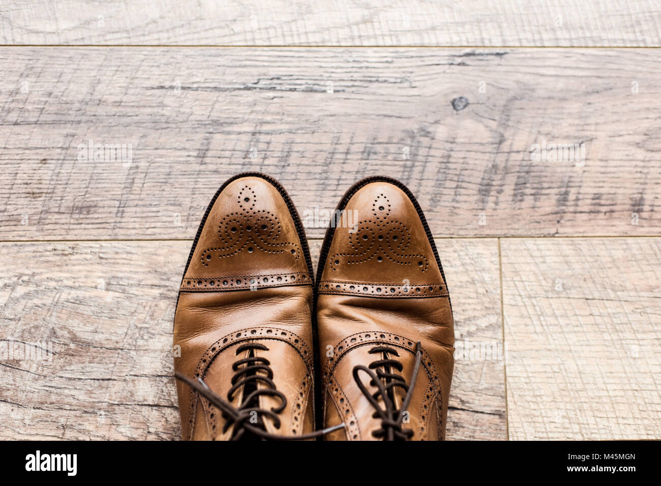 top view of pair of leather brown shoes on wooden floor Stock Photo - Alamy