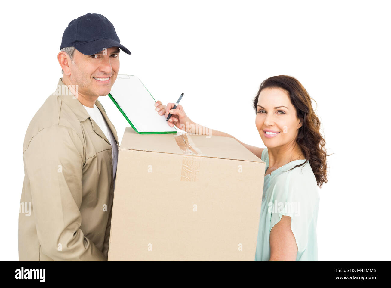 Female customer signing on paper with delivery man Stock Photo - Alamy