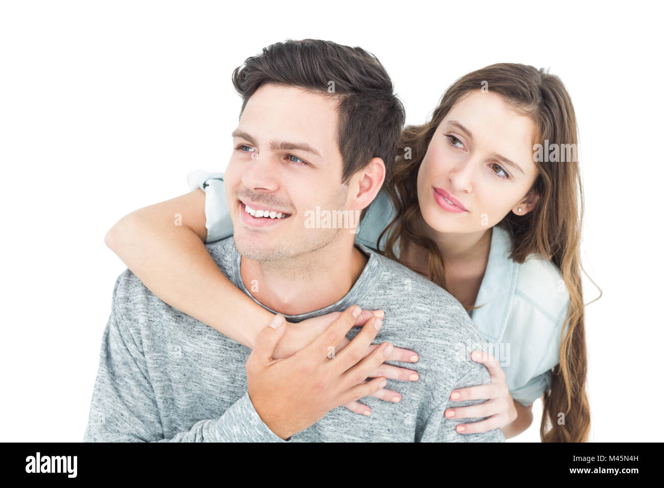 Couple embracing with arms around and looking away Stock Photo - Alamy