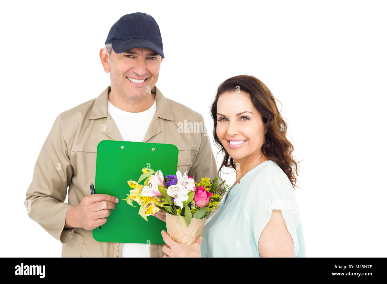 Female customer signing on paper with delivery man Stock Photo - Alamy