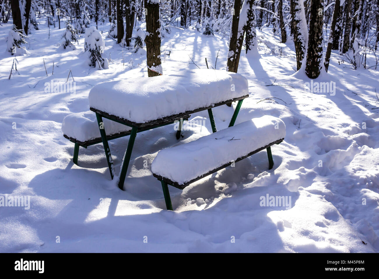 Table and benches in the park after a heavy snowfall. Interesting photo ...