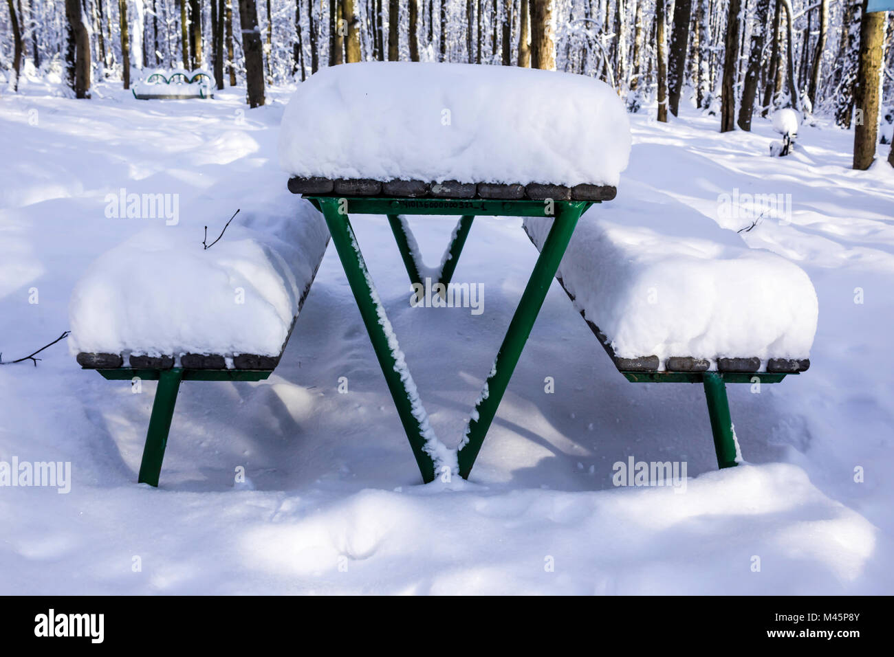 Table and benches in the park after a heavy snowfall. Interesting photo ...