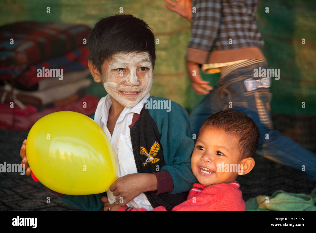 Local Burmese children in their humble home near wooden foot bridge U ...