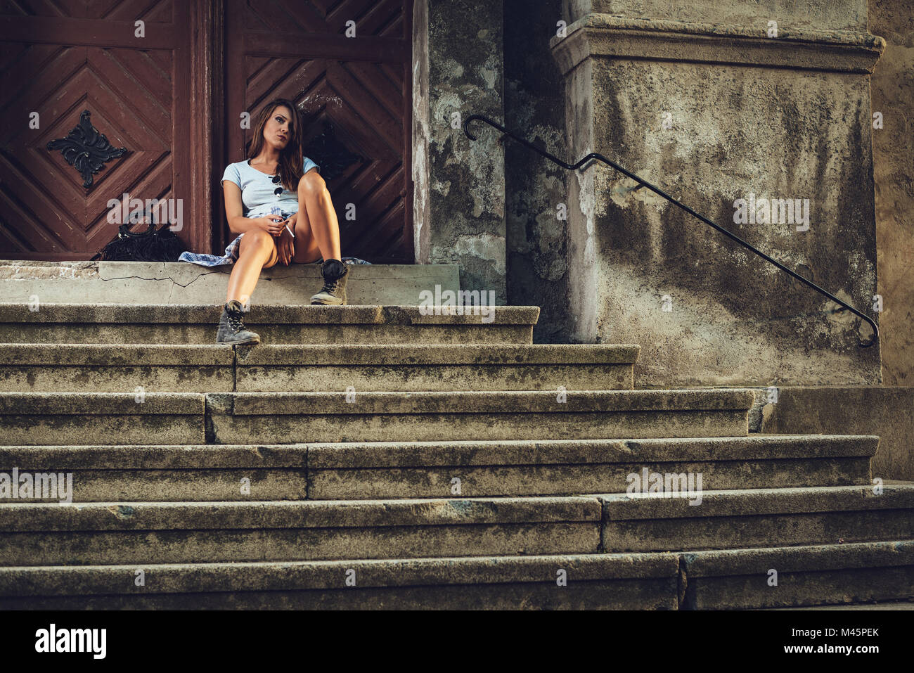 Sad girl sitting on stairs hi-res stock photography and images - Alamy
