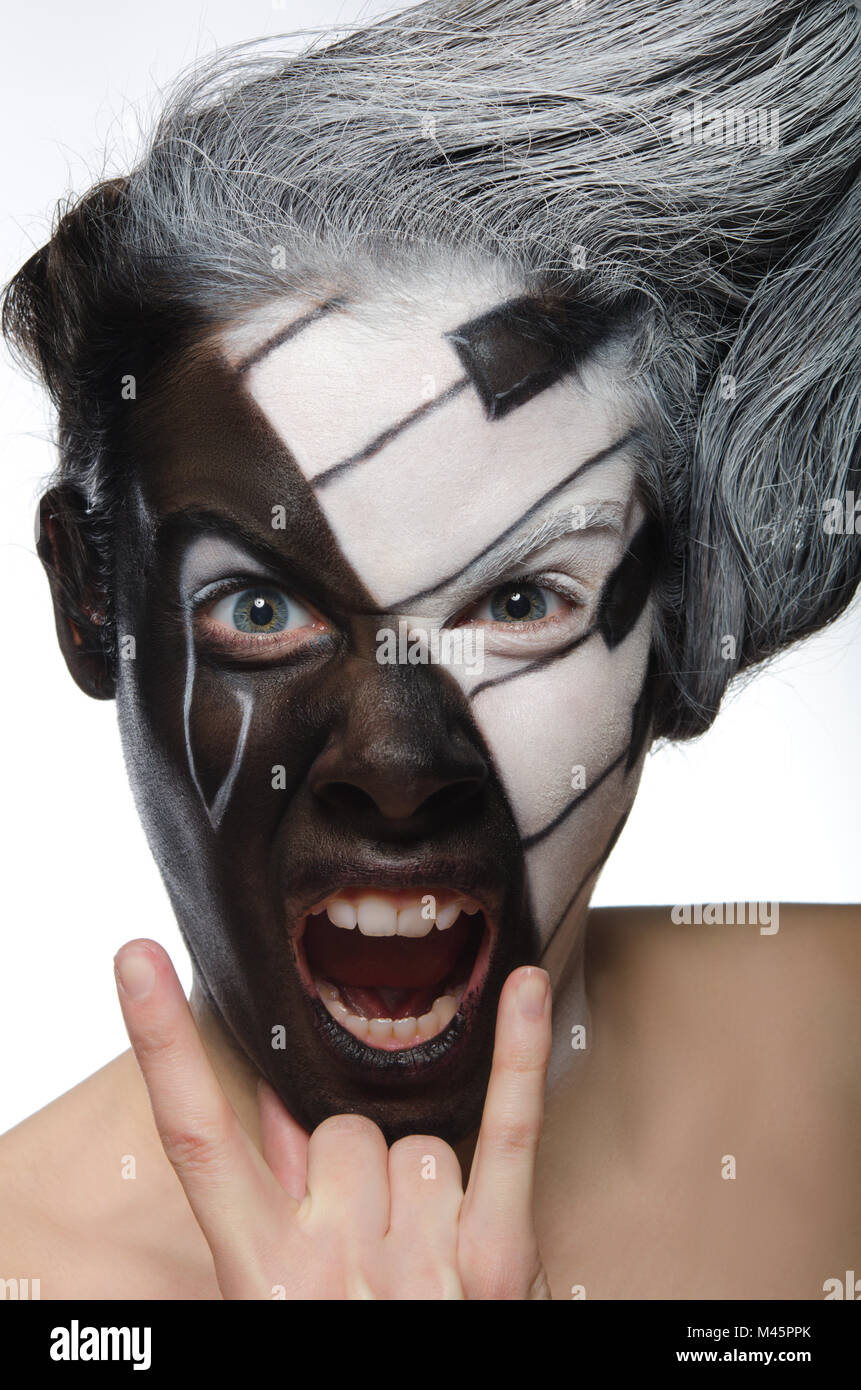 Portrait with musical makeup and rock gesture Stock Photo - Alamy