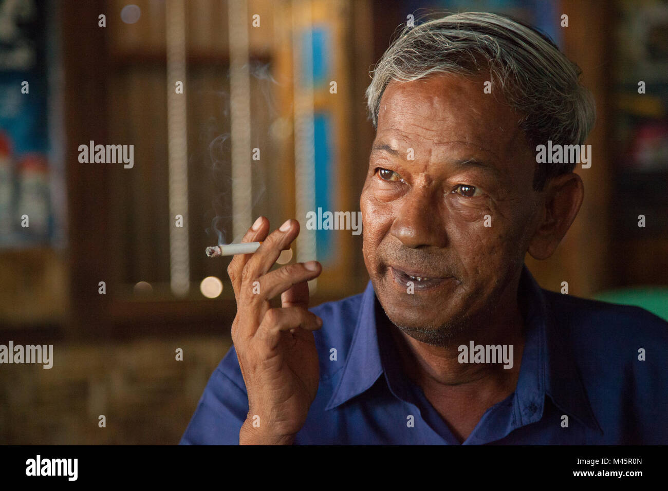 Local burmese man smoking cigarette in Myanmar Stock Photo - Alamy