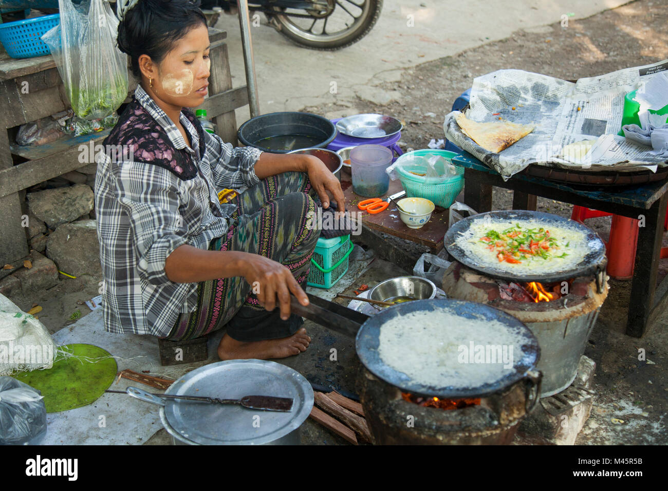 Woman making Burmese pancake and selling street food in Myanmar Stock ...