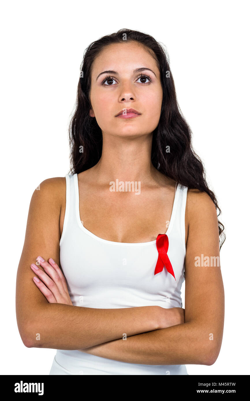 Serious woman with arms crossed with red ribbon on shirt Stock Photo ...