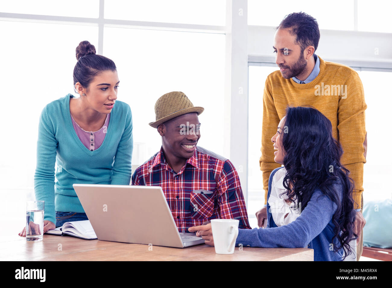Happy business people discussing at creative office Stock Photo - Alamy