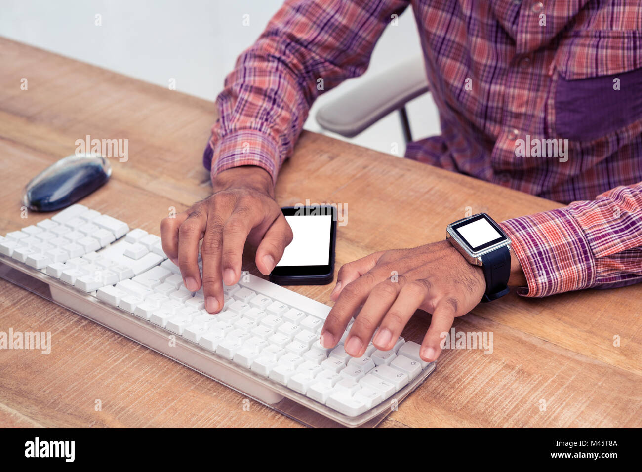 Businessman typing on computer keyboard on desk Stock Photo - Alamy