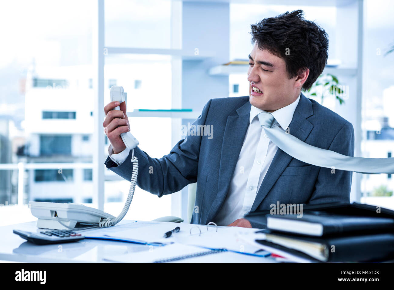 Angry asian businessman shouting on the phone Stock Photo - Alamy