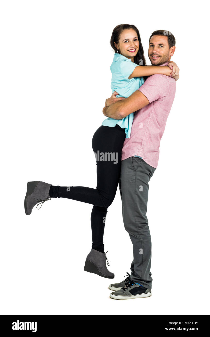 Full length of portrait of smiling couple hugging Stock Photo - Alamy
