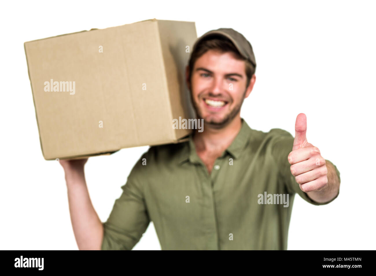 Handsome postman holding pack showing thumbs up Stock Photo - Alamy