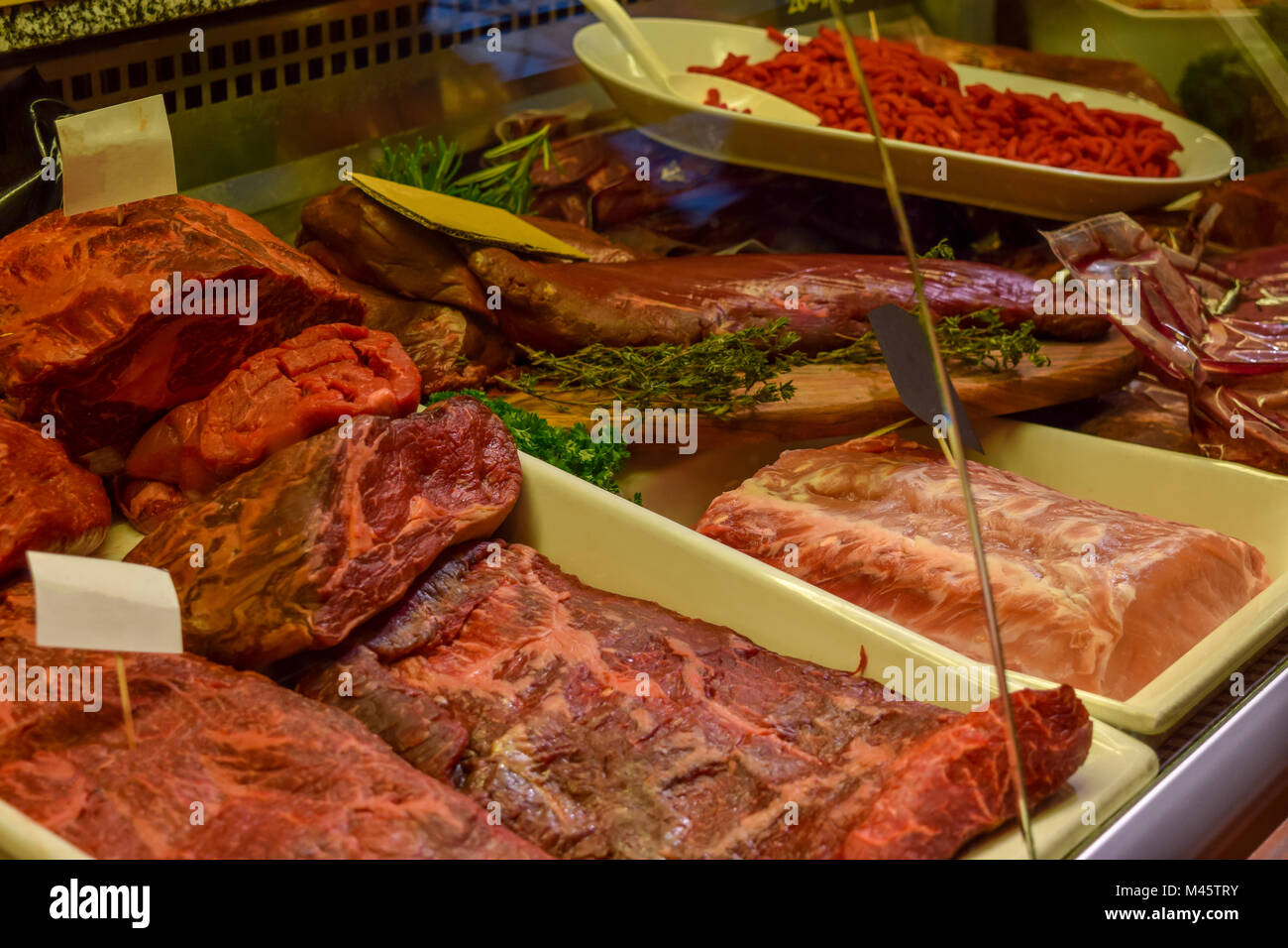 Large assortment of meat placed on counter in local Helsinki market ...