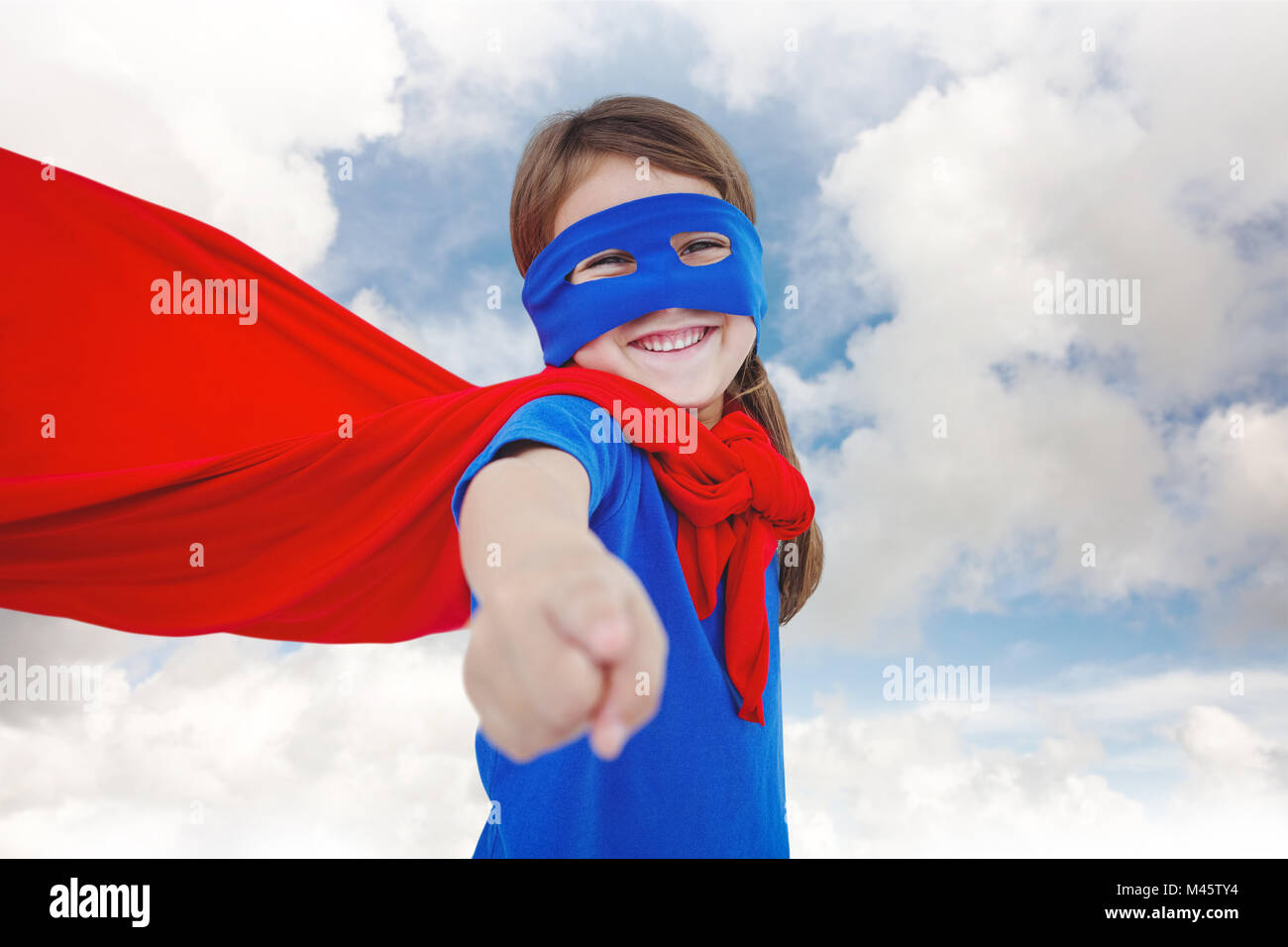 Composite image of smiling masked girl pretending to be superhero Stock ...
