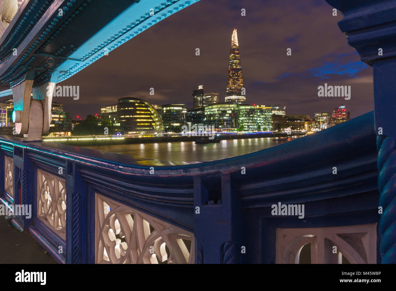 London - The metal construction of Tower Bride and skyscraper at dusk ...