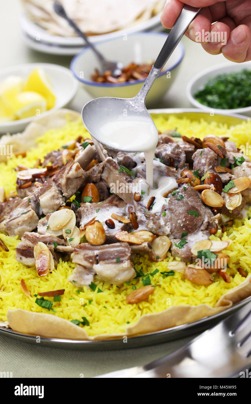 mansaf, Jordanian national dish, pouring yogurt sauce Stock Photo - Alamy