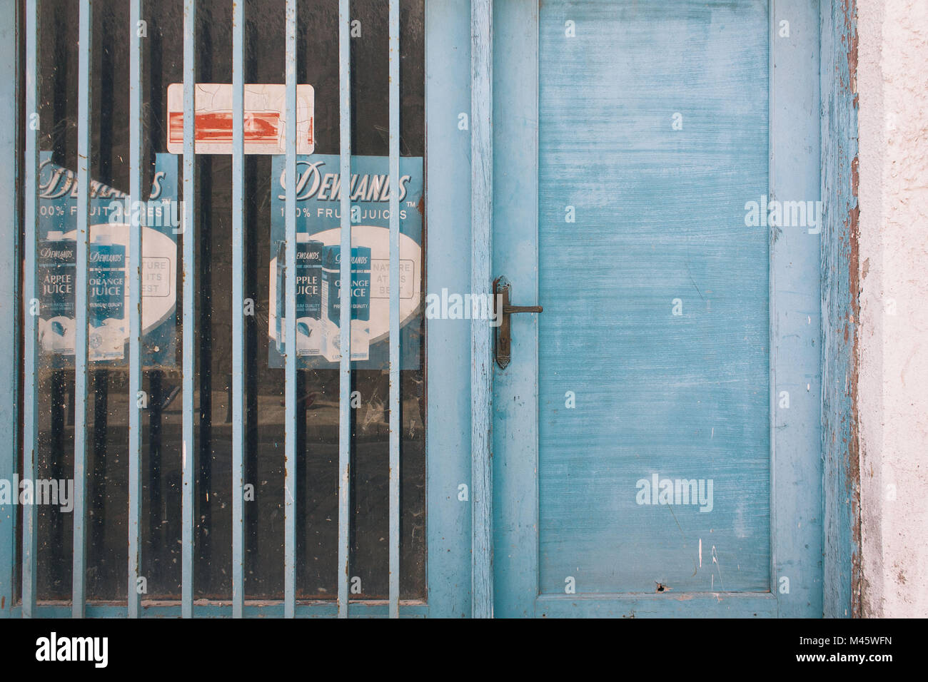 Close up of an old shop in cyprus, blue door and railings Stock Photo ...