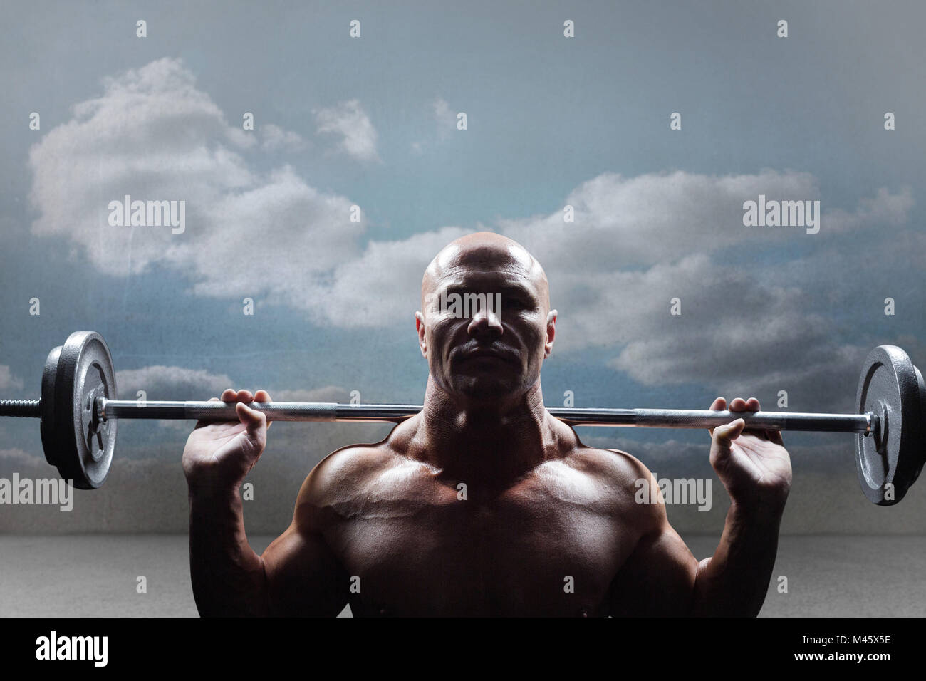 Composite image of portrait of bald man lifting crossfit Stock Photo ...