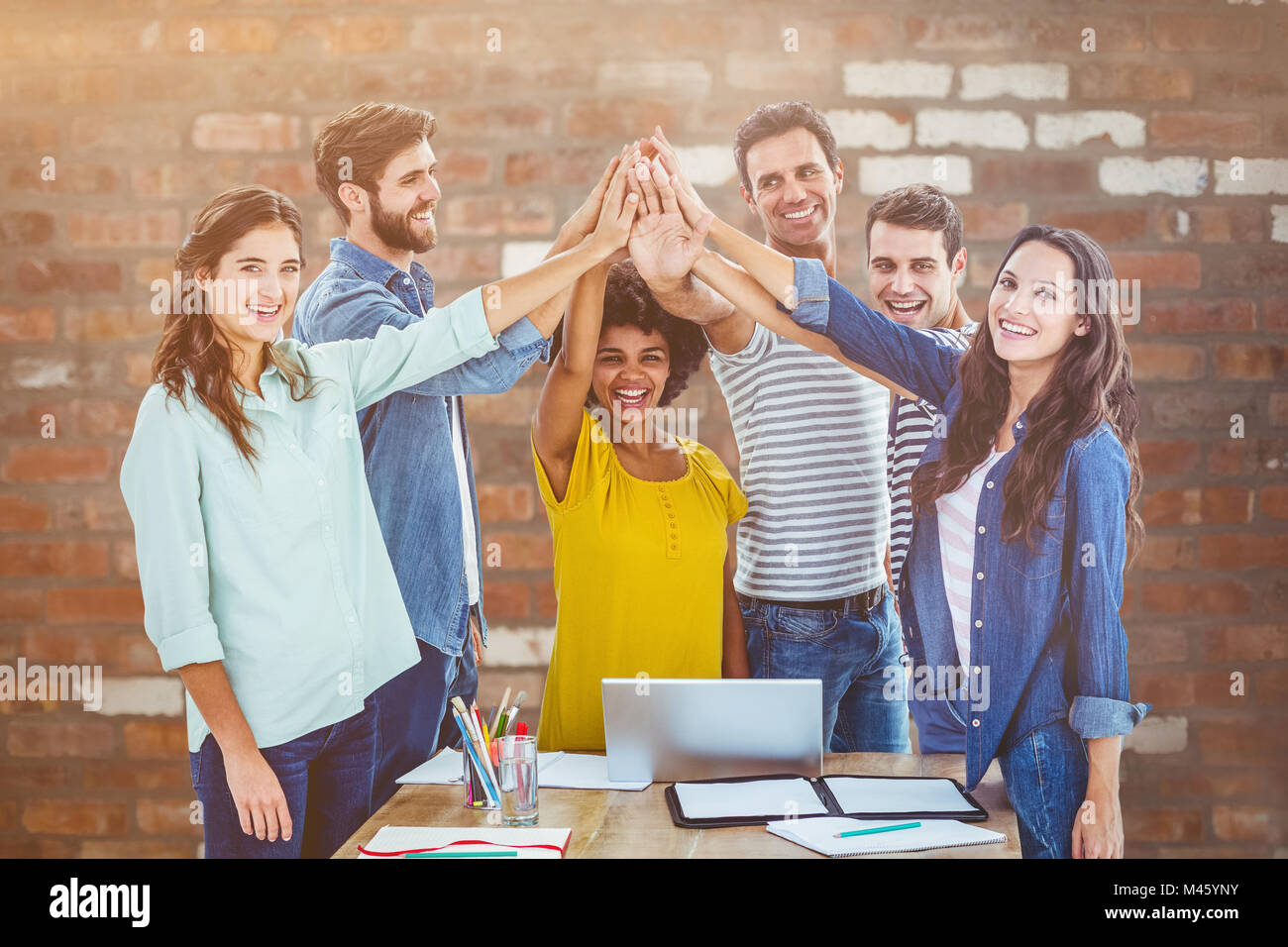 Composite image of group of young colleagues using laptop Stock Photo - Alamy