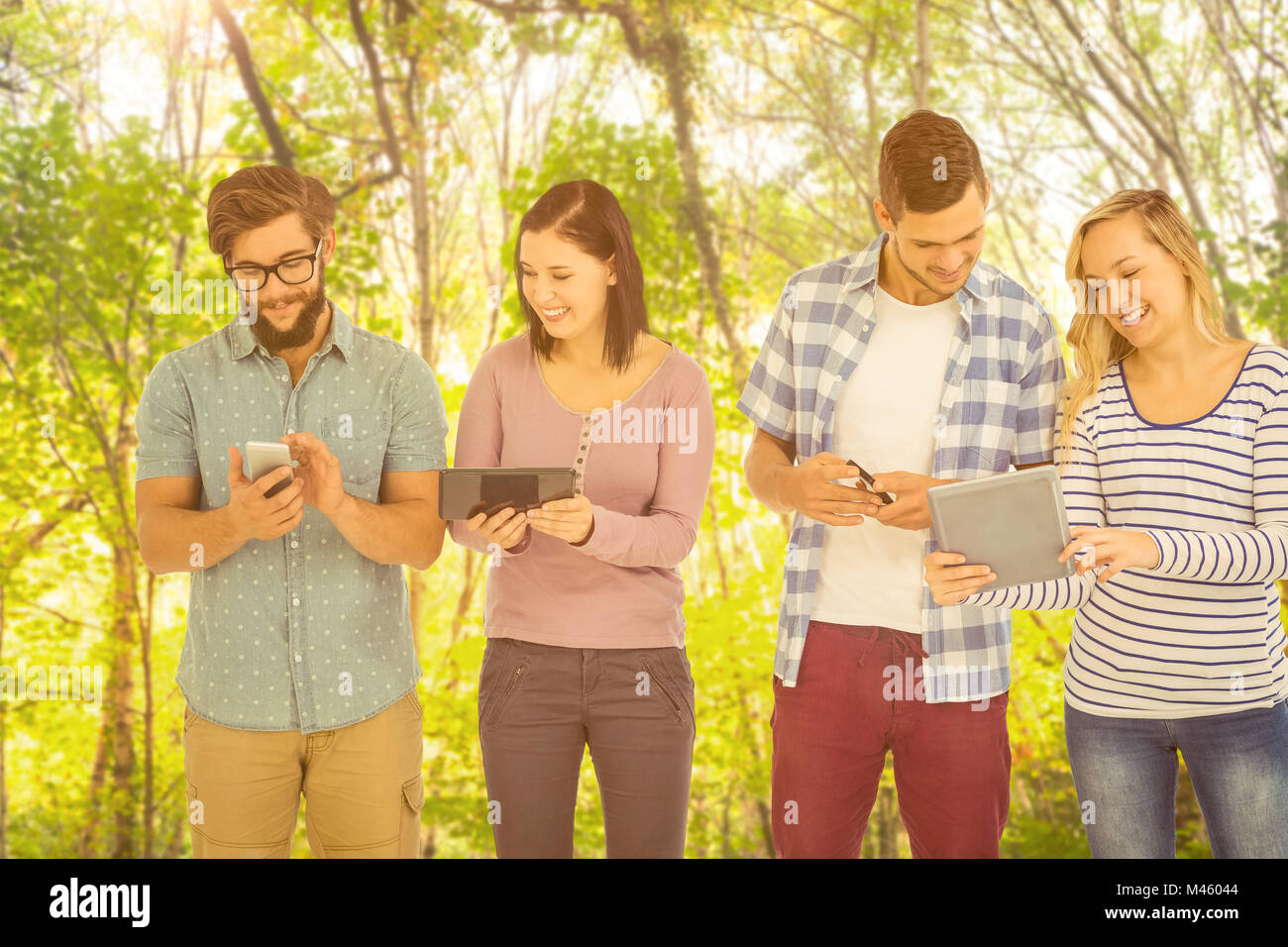 Composite image of smiling business people using electronic gadgets ...