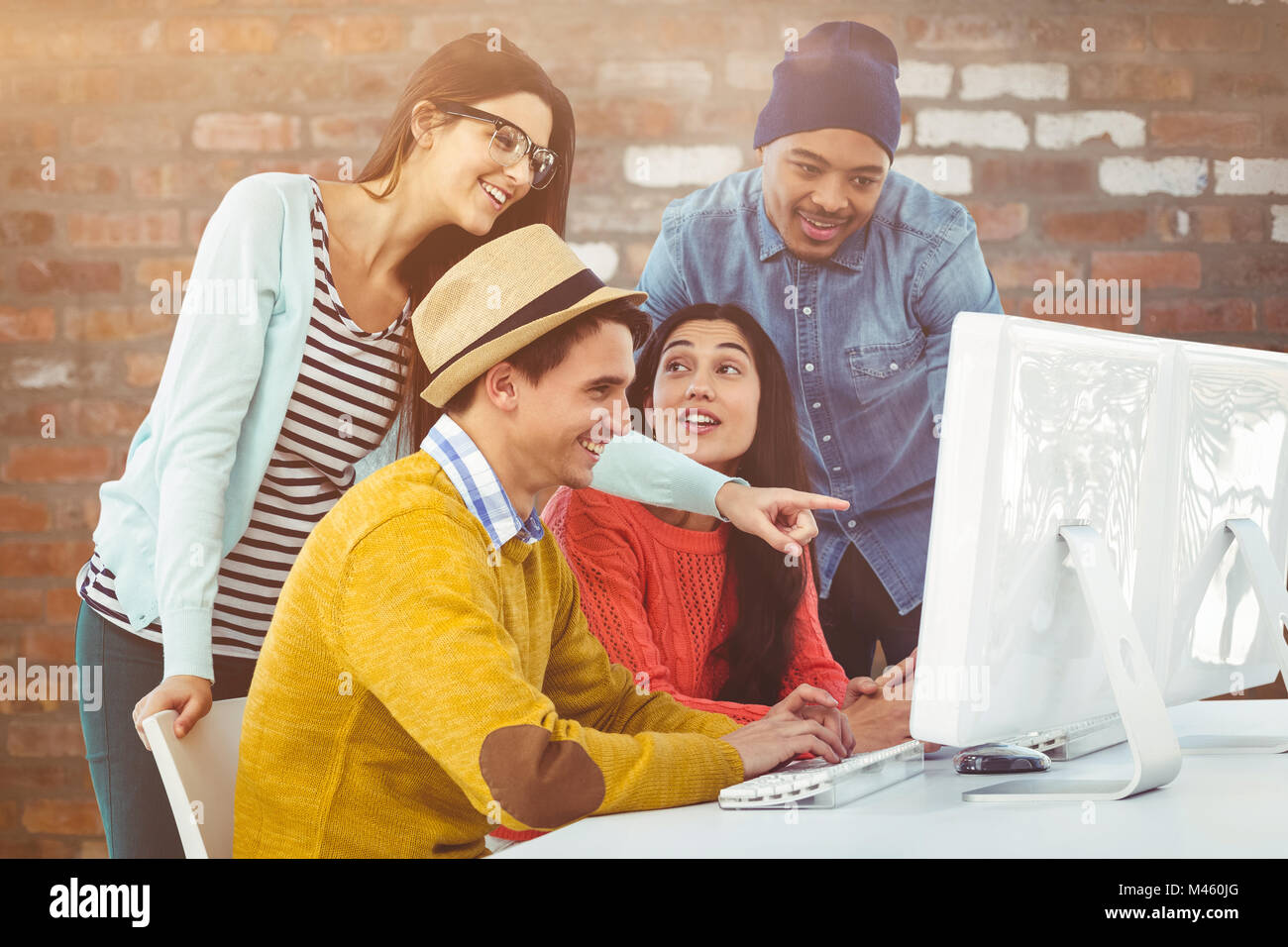 Composite image of young creative team having a meeting Stock Photo - Alamy