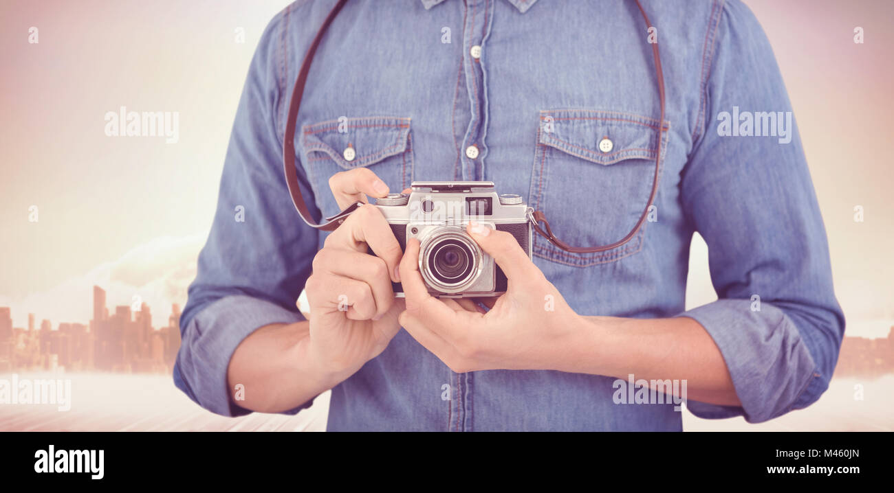 Composite image of mid section of man adjusting camera lens Stock Photo ...