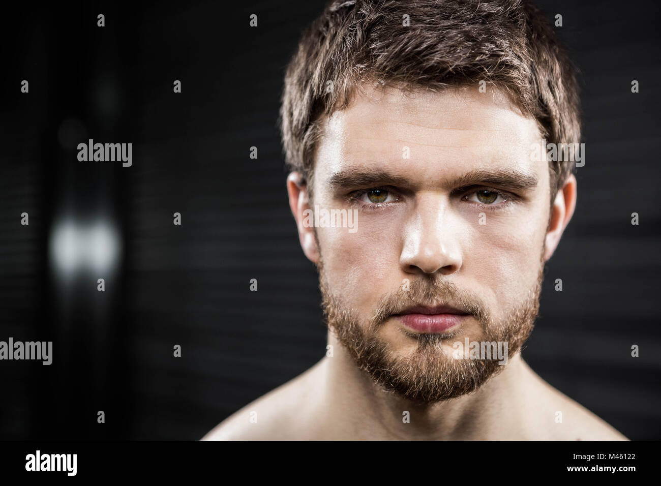 Determined muscular man looking at the camera Stock Photo - Alamy