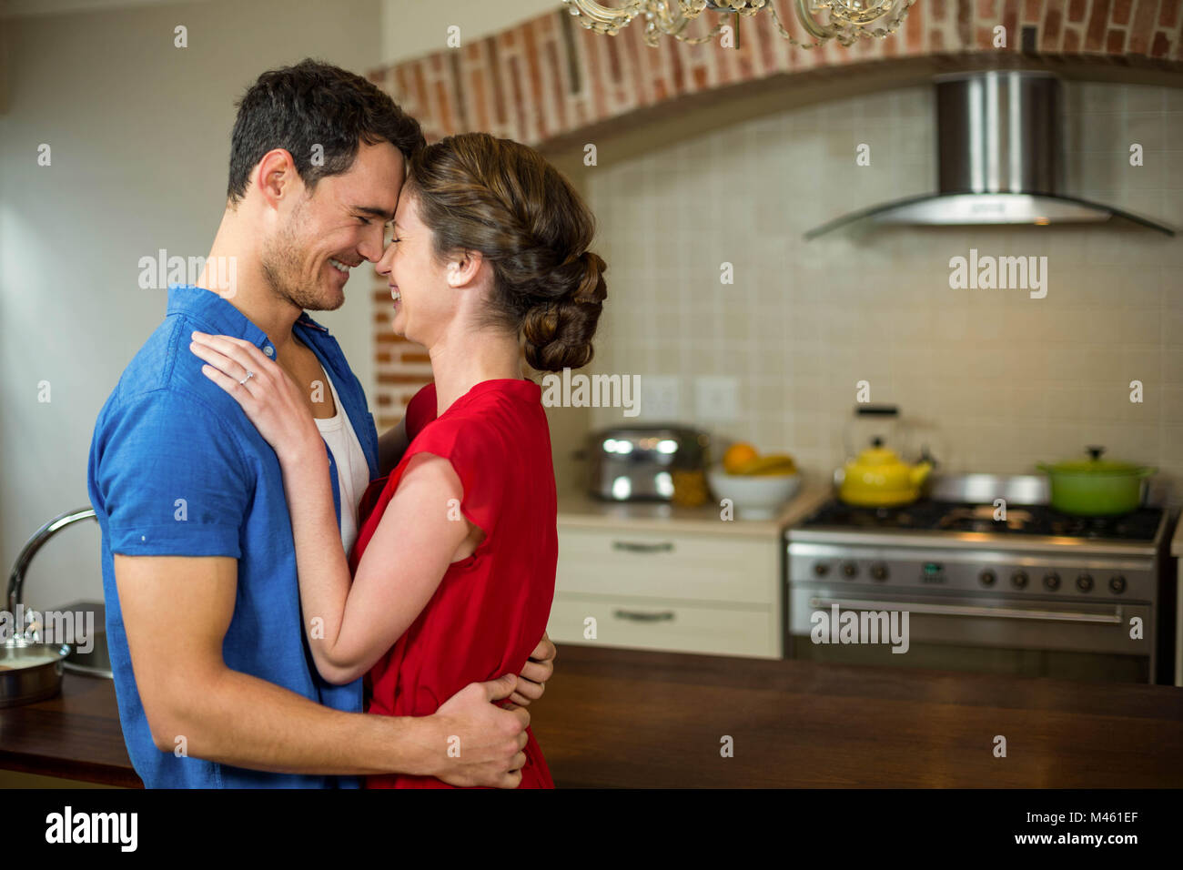 Romantic couple standing face to face and embracing each other Stock ...