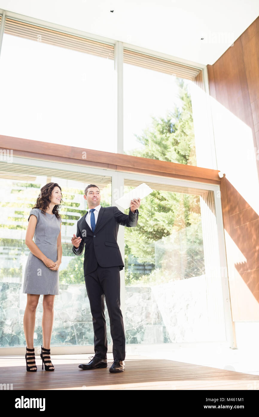 Real-estate agent showing young woman new home Stock Photo - Alamy