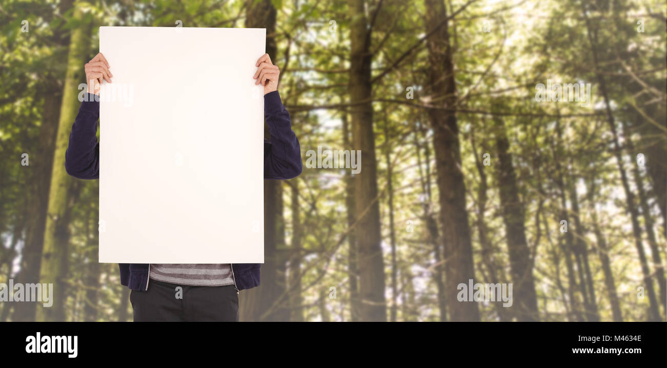 Composite image of man showing billboard in front of face Stock Photo ...