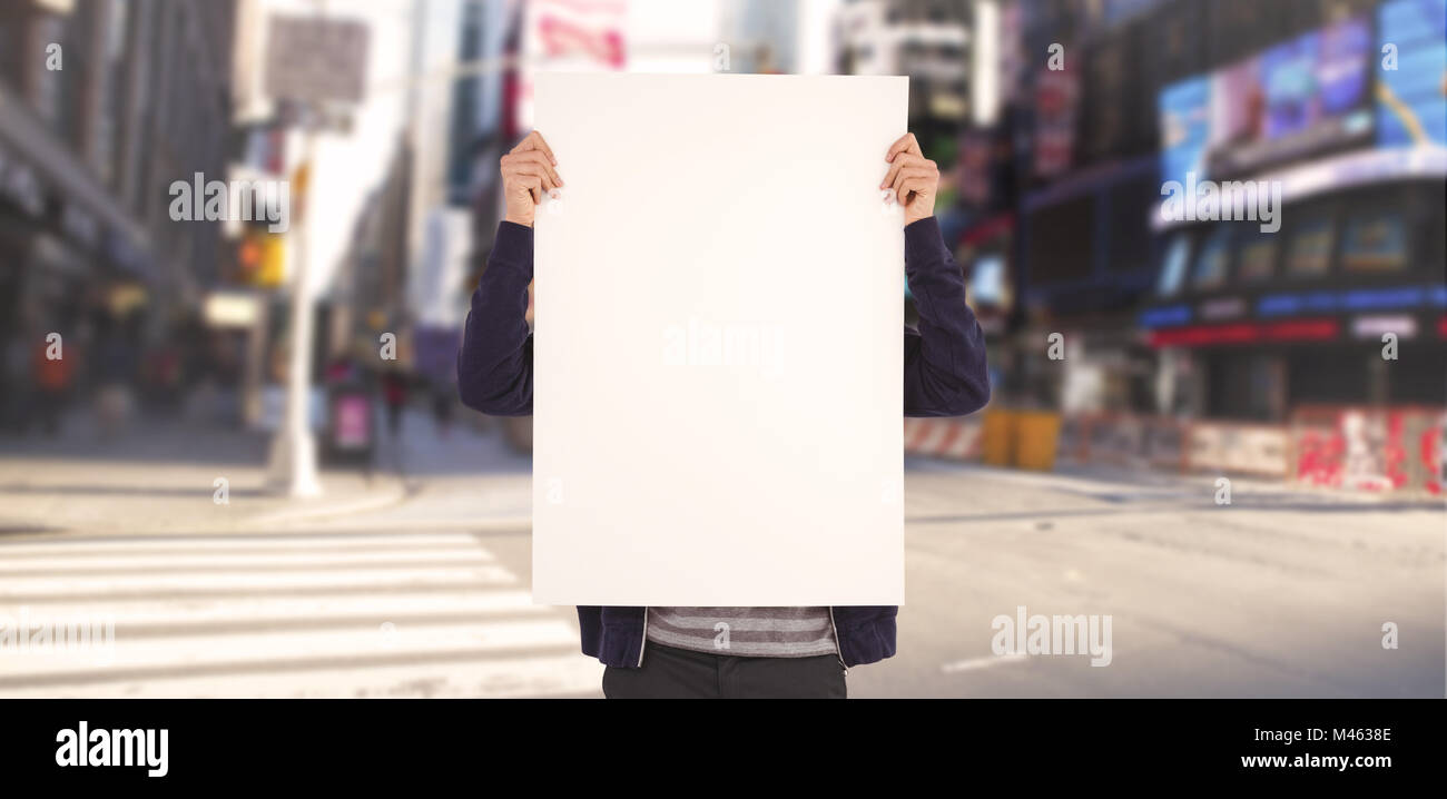 Composite image of man showing billboard in front of face Stock Photo ...