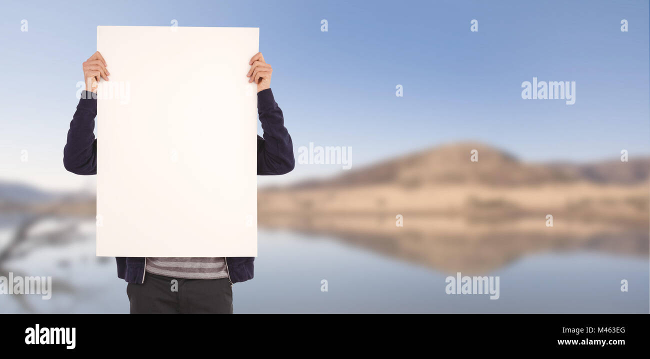 Composite image of man showing billboard in front of face Stock Photo ...