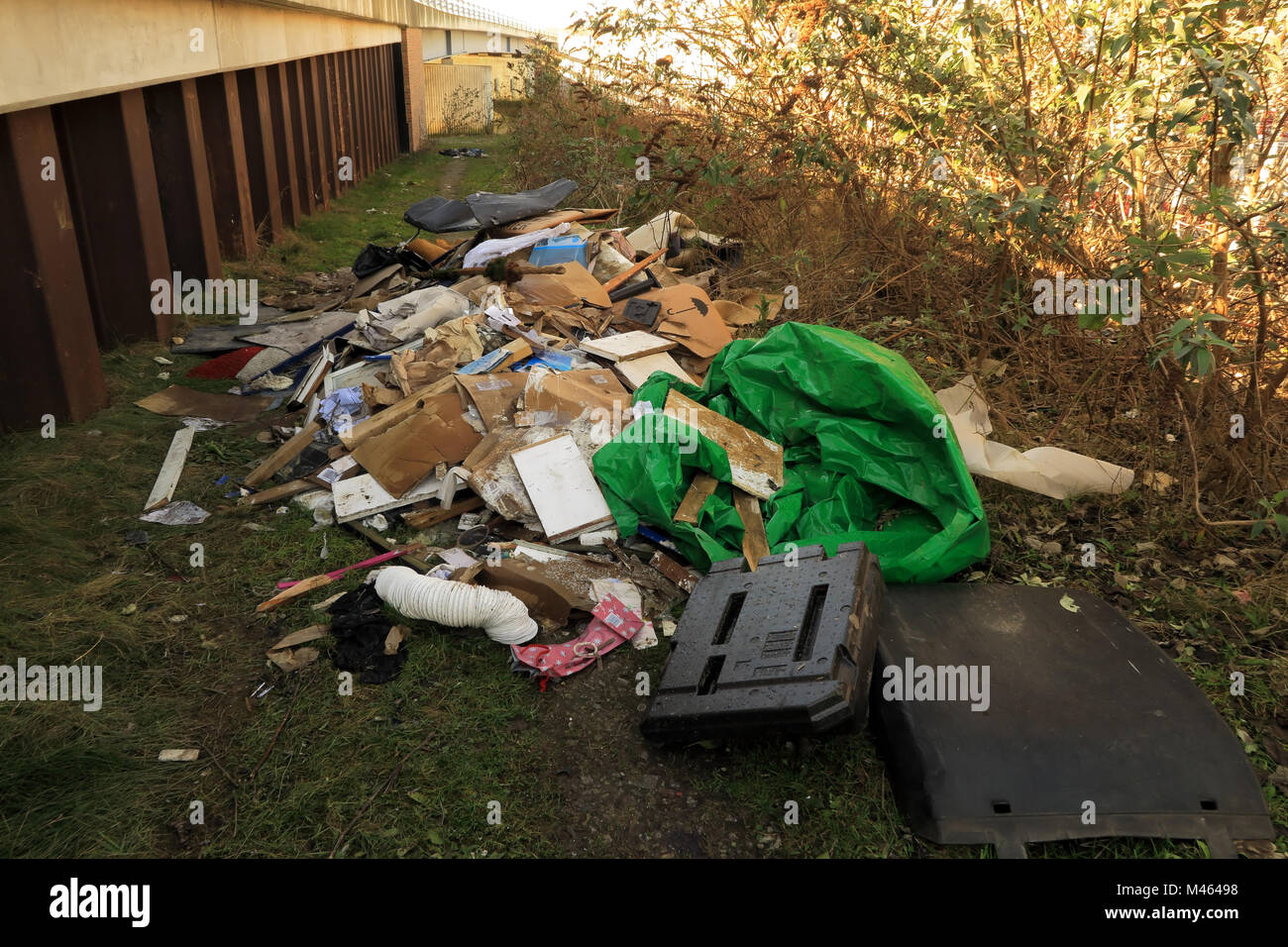 Piles of rubbish thrown on to a public footpath Stock Photo - Alamy