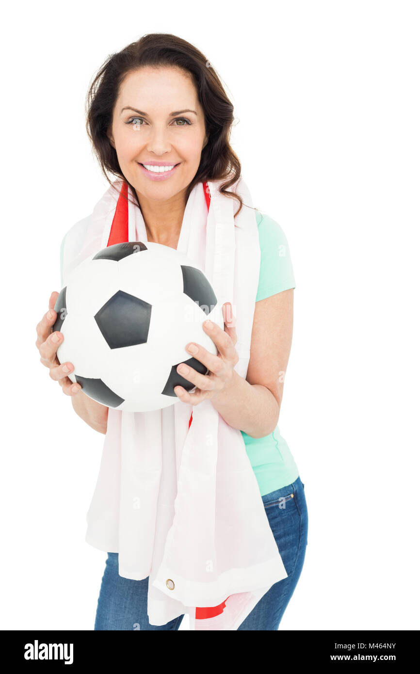 Pretty brunette with thumbs up holding soccer ball Stock Photo - Alamy