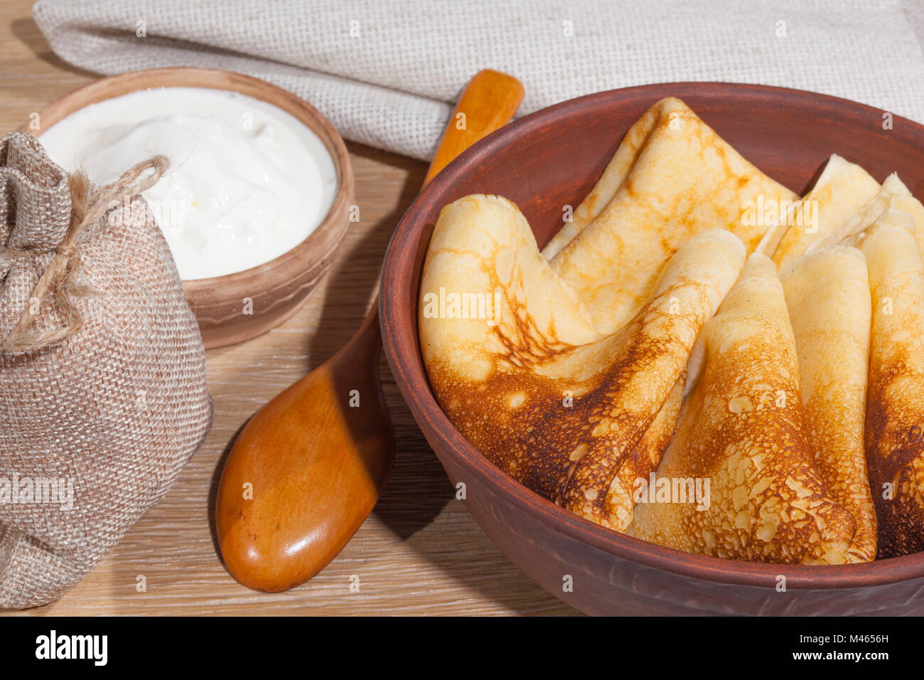 traditional oily food in vintage style: pancakes with sour cream in and ...