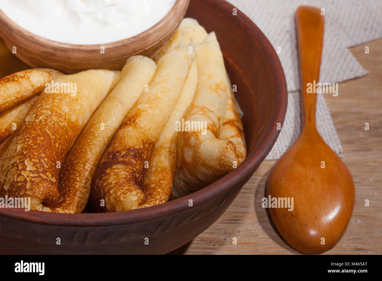 traditional oily food in vintage style: pancakes with sour cream in and ...
