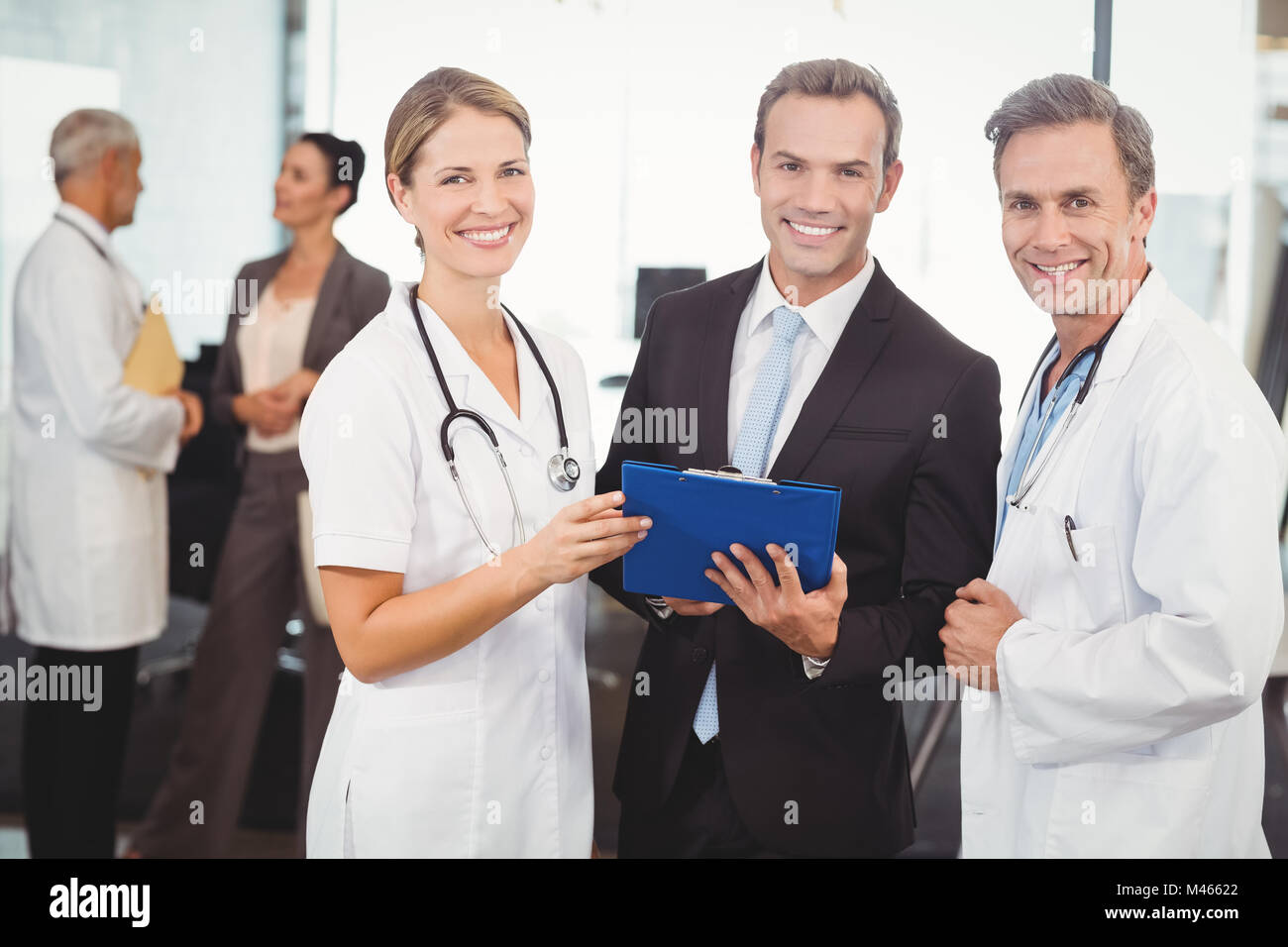 Portrait of happy medical team with clipboard Stock Photo - Alamy
