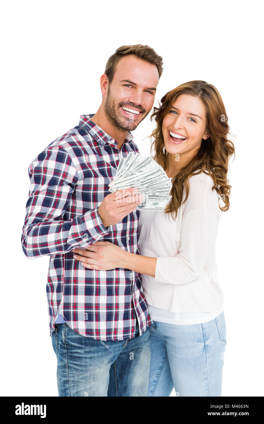 Happy young couple holding fanned out currency note Stock Photo - Alamy