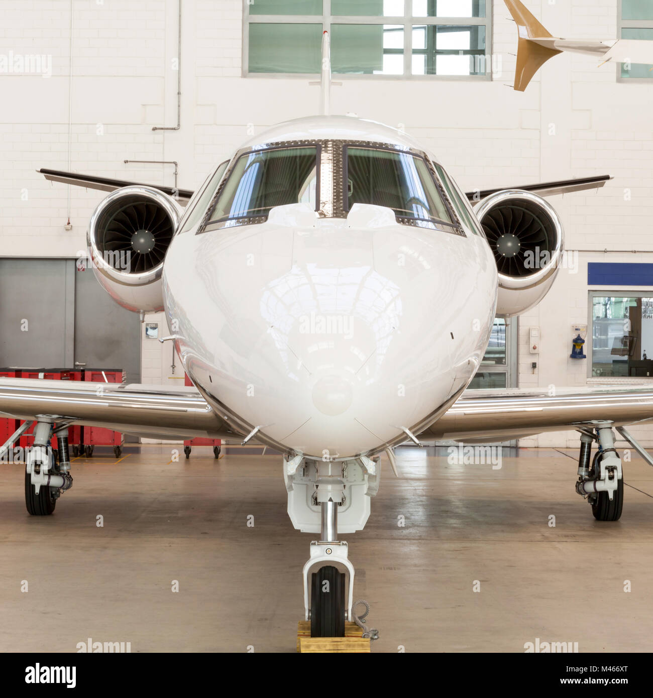Small private corporate jet in a hangar Stock Photo - Alamy