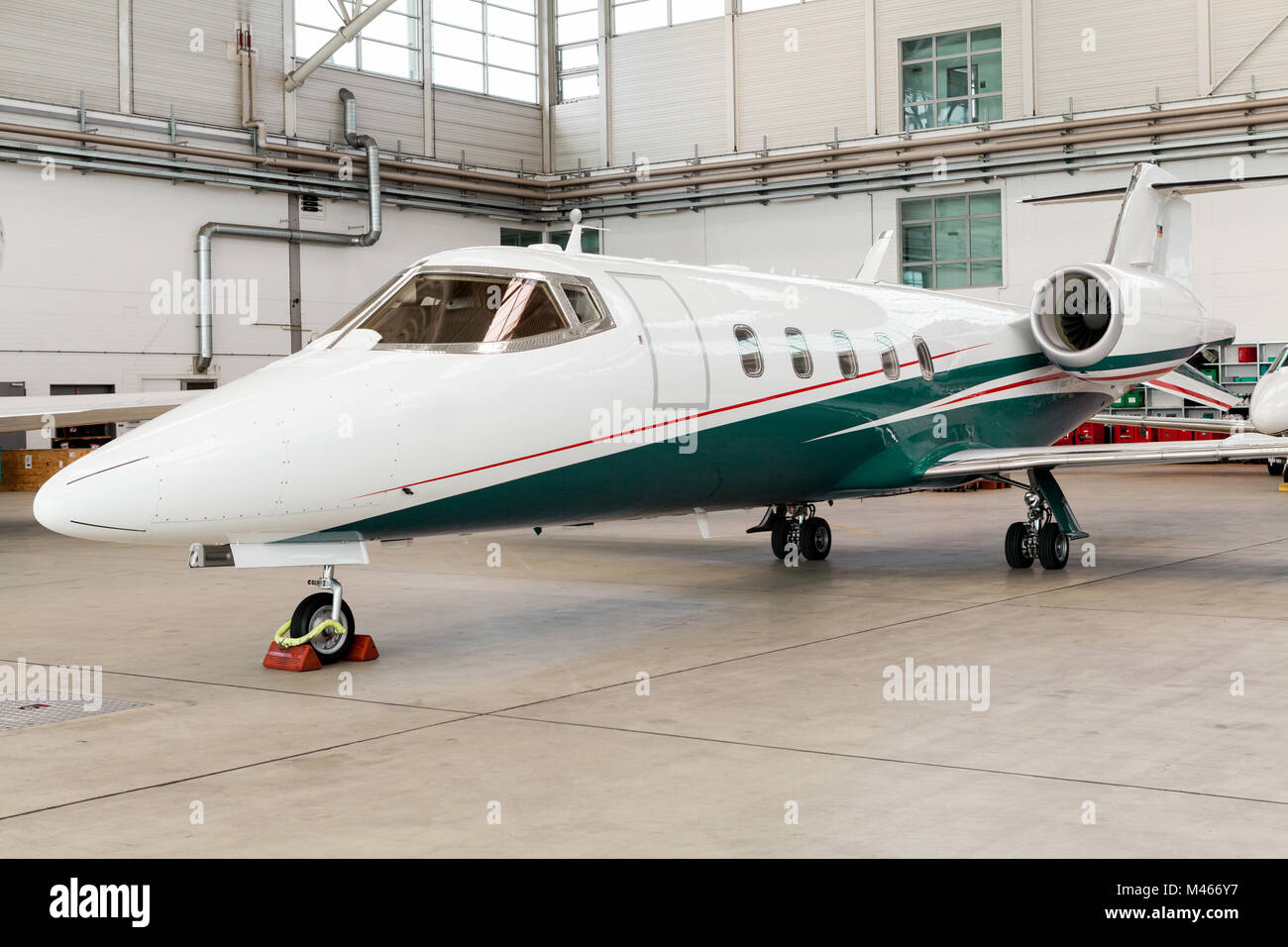 Small private corporate jet in a hangar Stock Photo - Alamy