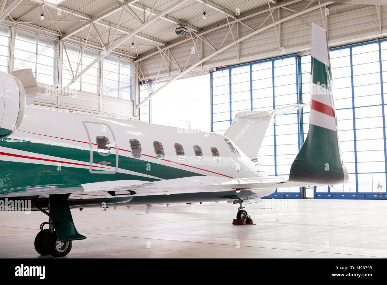 Small private corporate jet in a hangar Stock Photo - Alamy