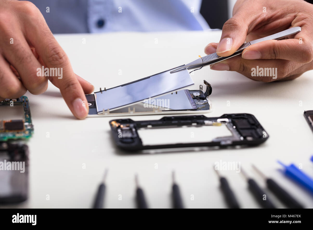 Close-up Of A Technician's Hand Fixing Damaged Screen On Mobile Phone ...