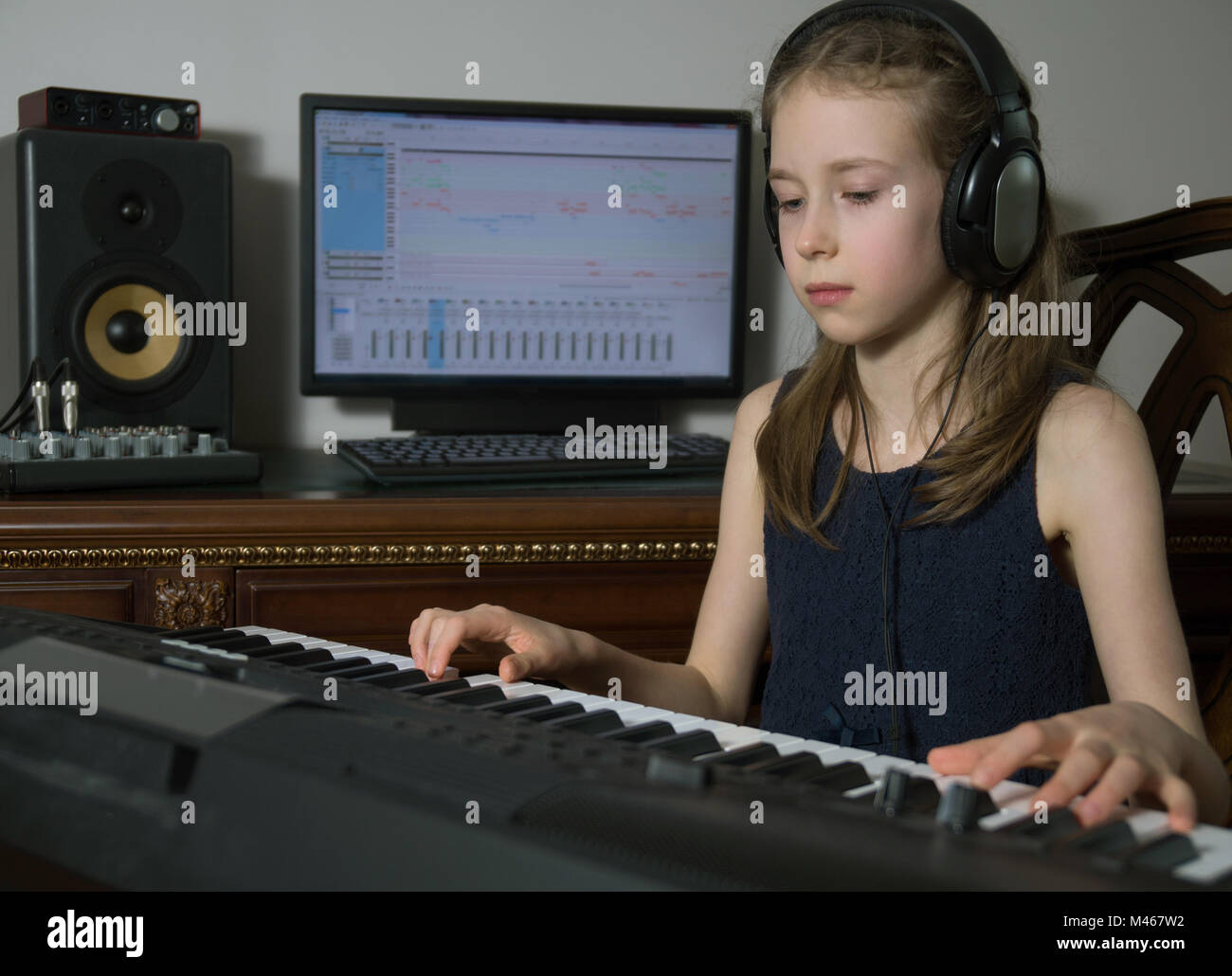 Little girl recording a song in home music studio Stock Photo - Alamy