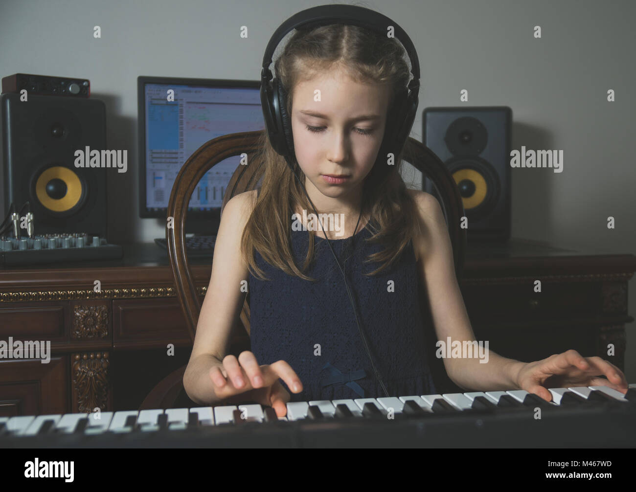 Little girl recording a song in home music studio Stock Photo - Alamy
